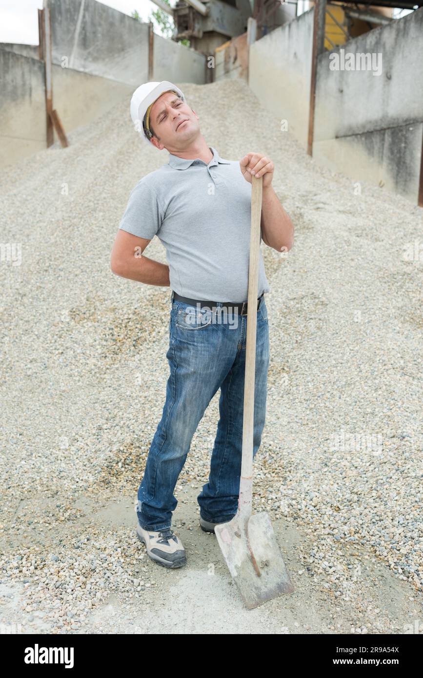 Man shoveling cement hi-res stock photography and images - Alamy