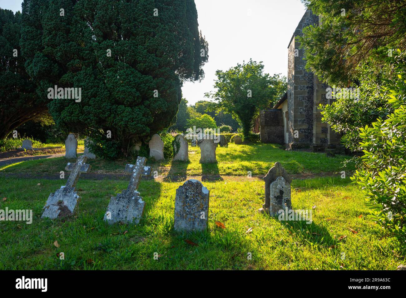 Gravestones at graves in a churchyard cemetery at a church in England ...