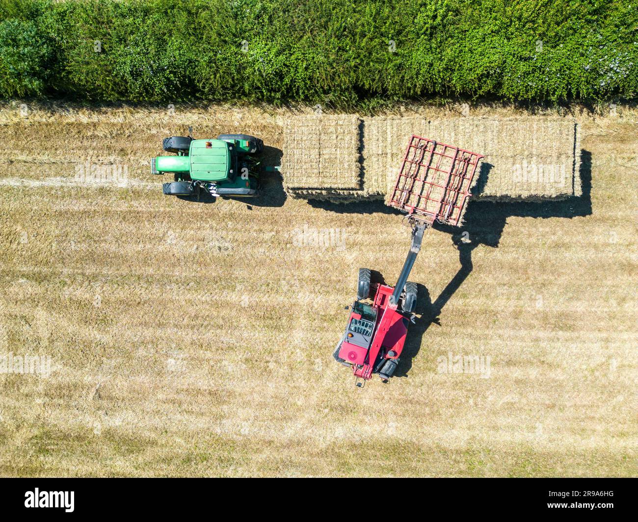 Hay cutting and harvesting with Farm Machinery bale grabber in summer ...