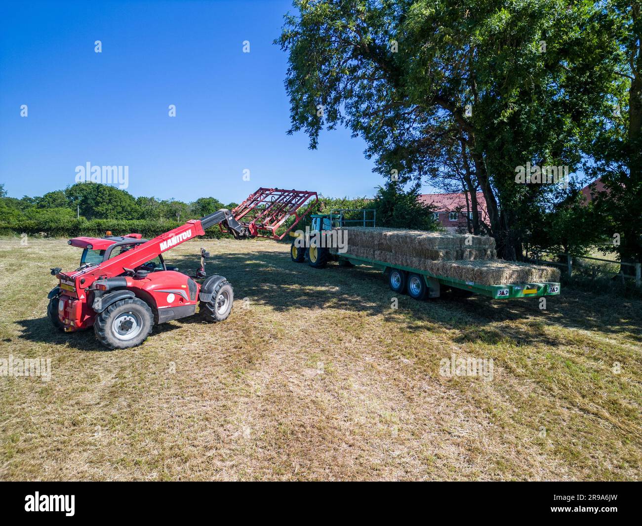 Hay cutting and harvesting with Farm Machinery bale grabber in summer ...