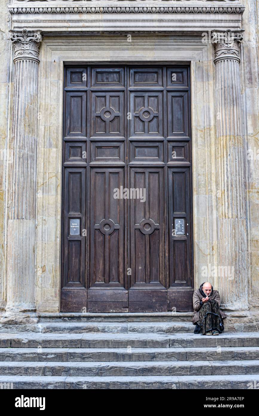 Florence, Italy - 21 Nov, 2022: A homeless man on the steps of the ...