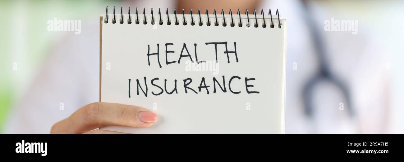 Female hand holding notepad with health insurance lettering Stock Photo ...