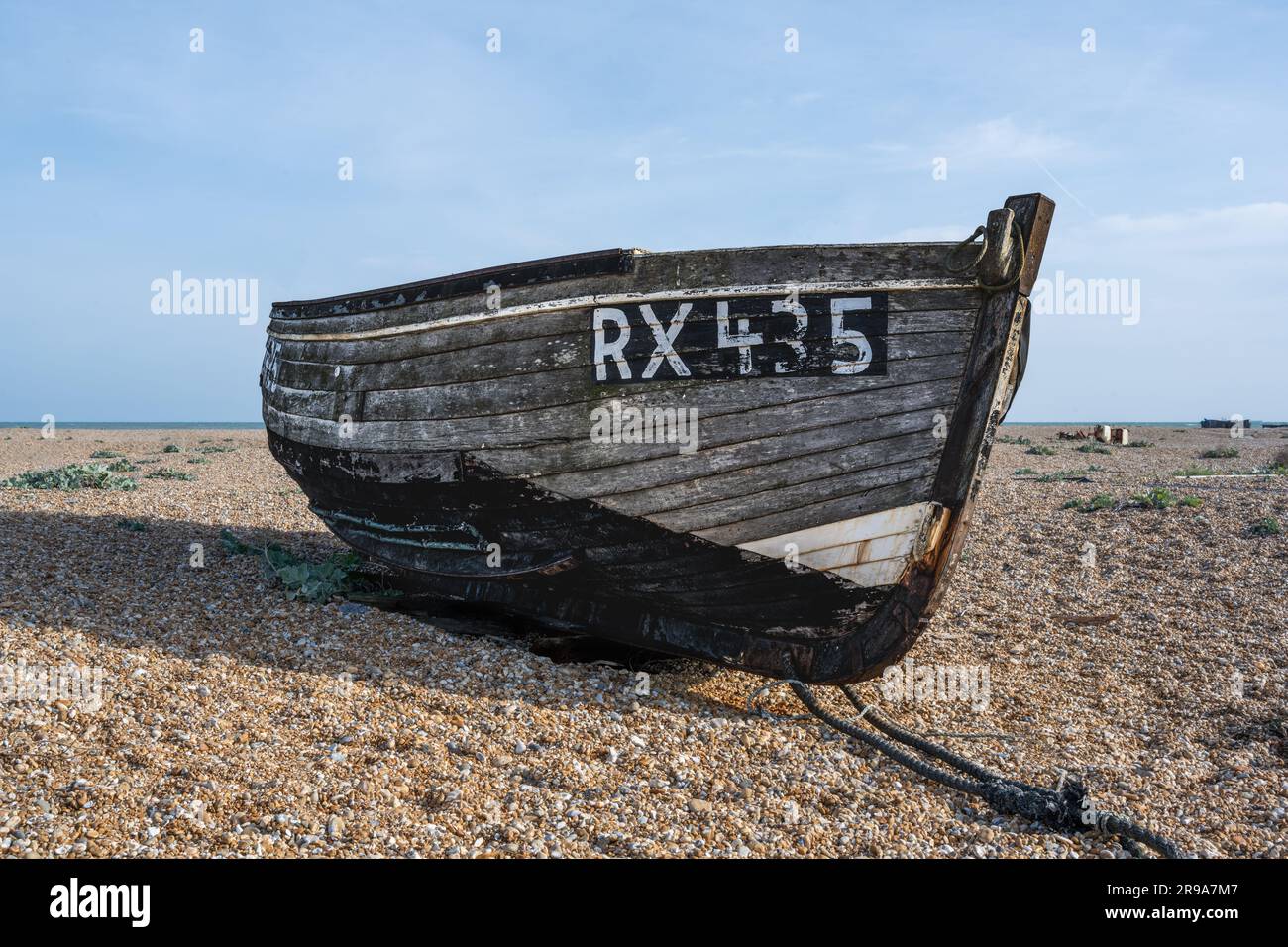 Beached wooden fishing boat on Kent shore Stock Photo - Alamy