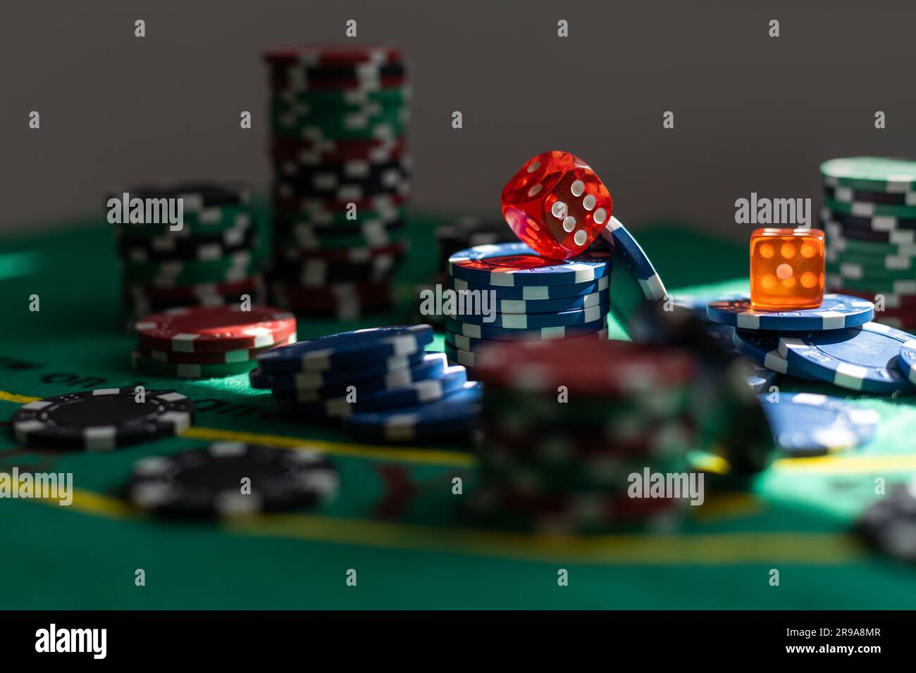 Poker Chips on a gaming table with dramatic lighting Stock Photo - Alamy