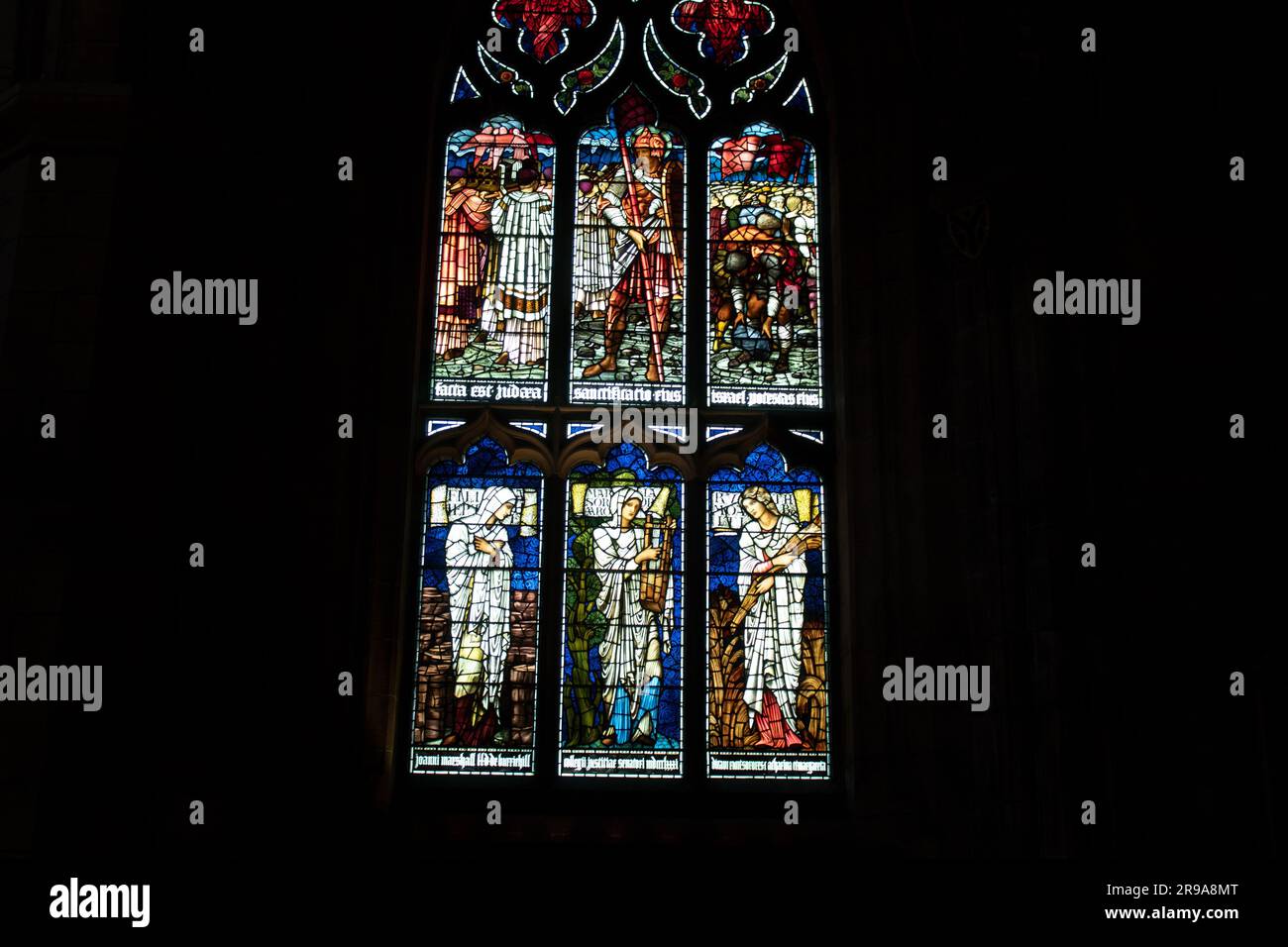 An interior shot of a colorful church stained glass window, illuminated ...