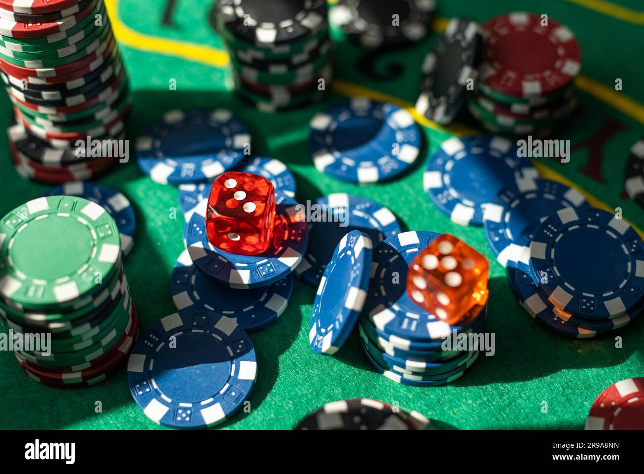 Poker Chips on a gaming table with dramatic lighting Stock Photo - Alamy