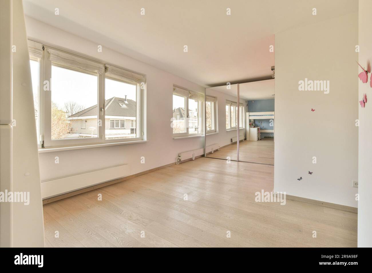 an empty living room with wood flooring and white walls in the room is ...