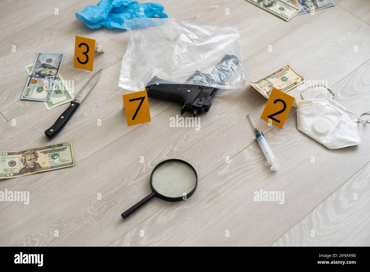 Evidence markers with knife and magazine of gun on the ground. Sign of ...