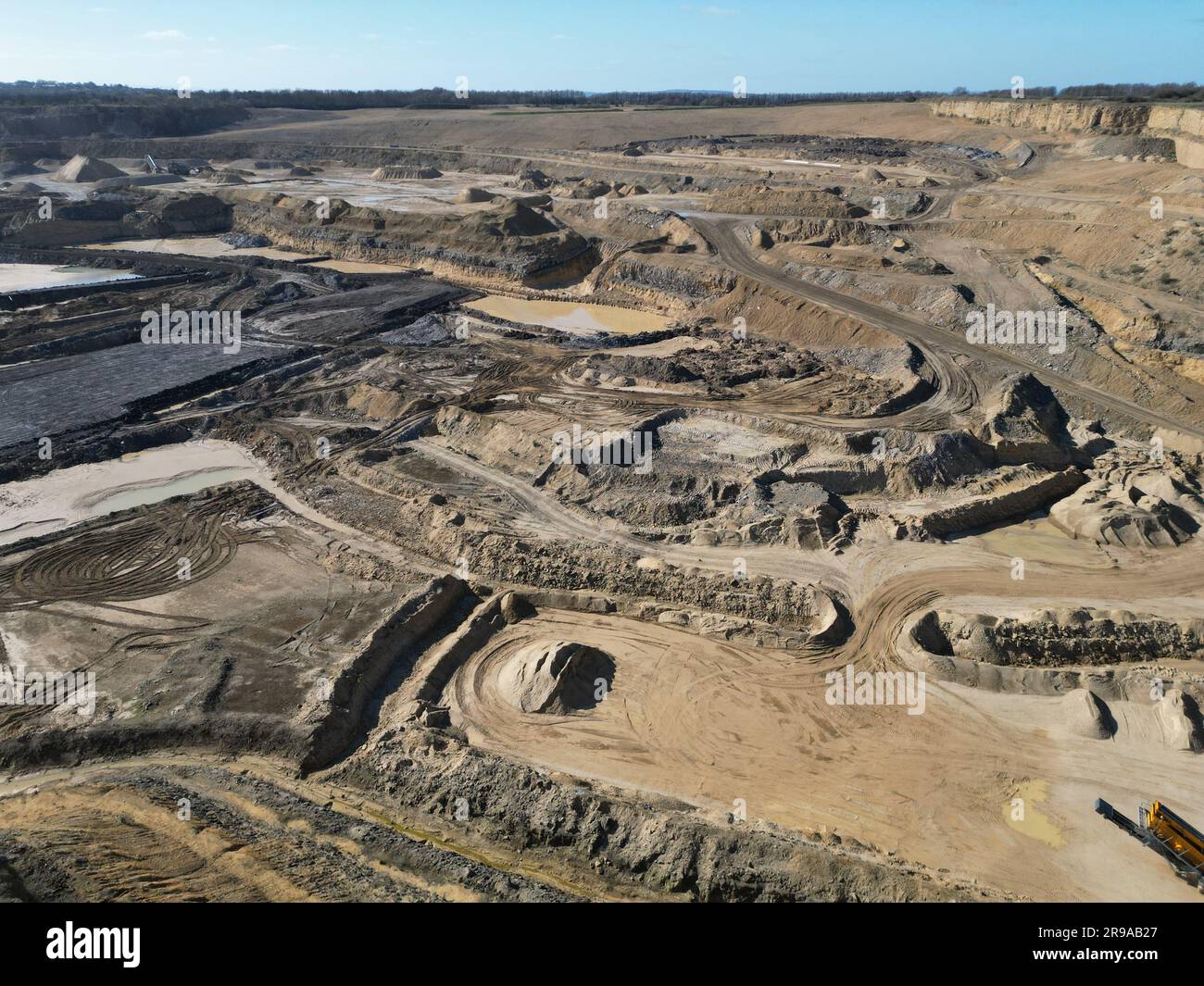 An aerial view of an open-cast mine situated in a desert landscape ...