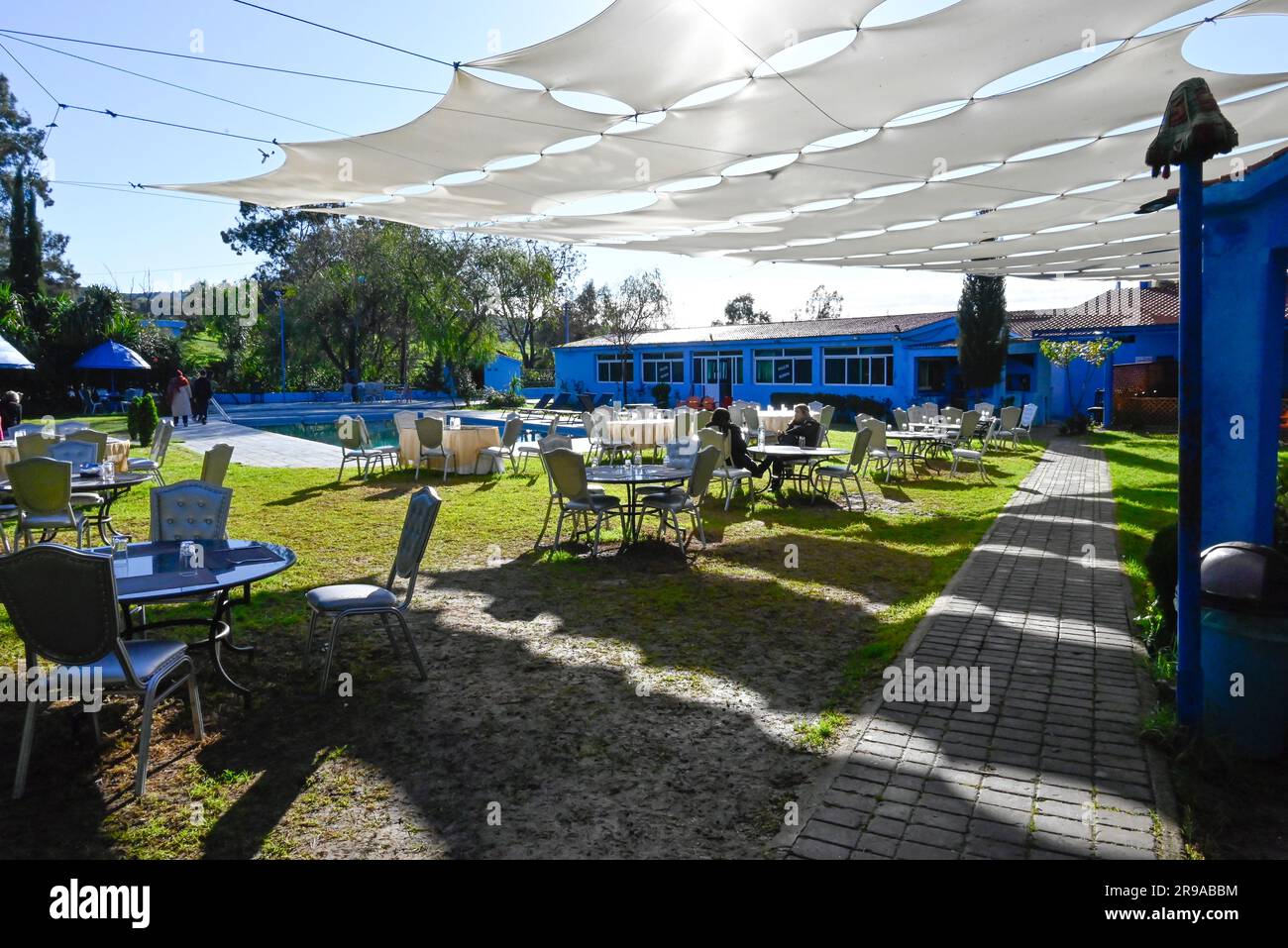 Near the Riff mountains, an inviting outdoor dining area by pool with ...