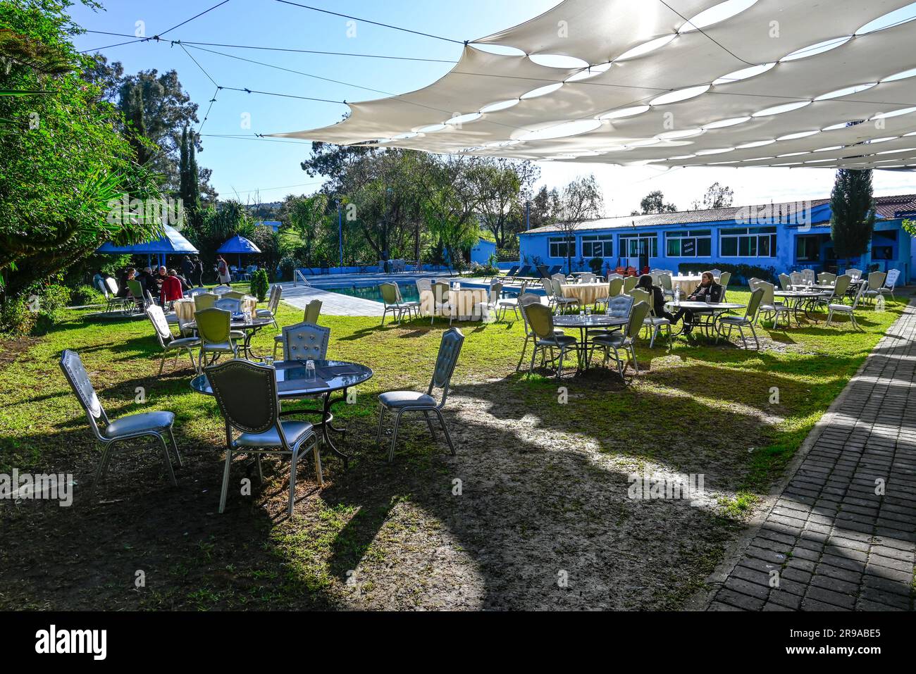 Near the Riff mountains, an inviting outdoor dining area by pool with ...