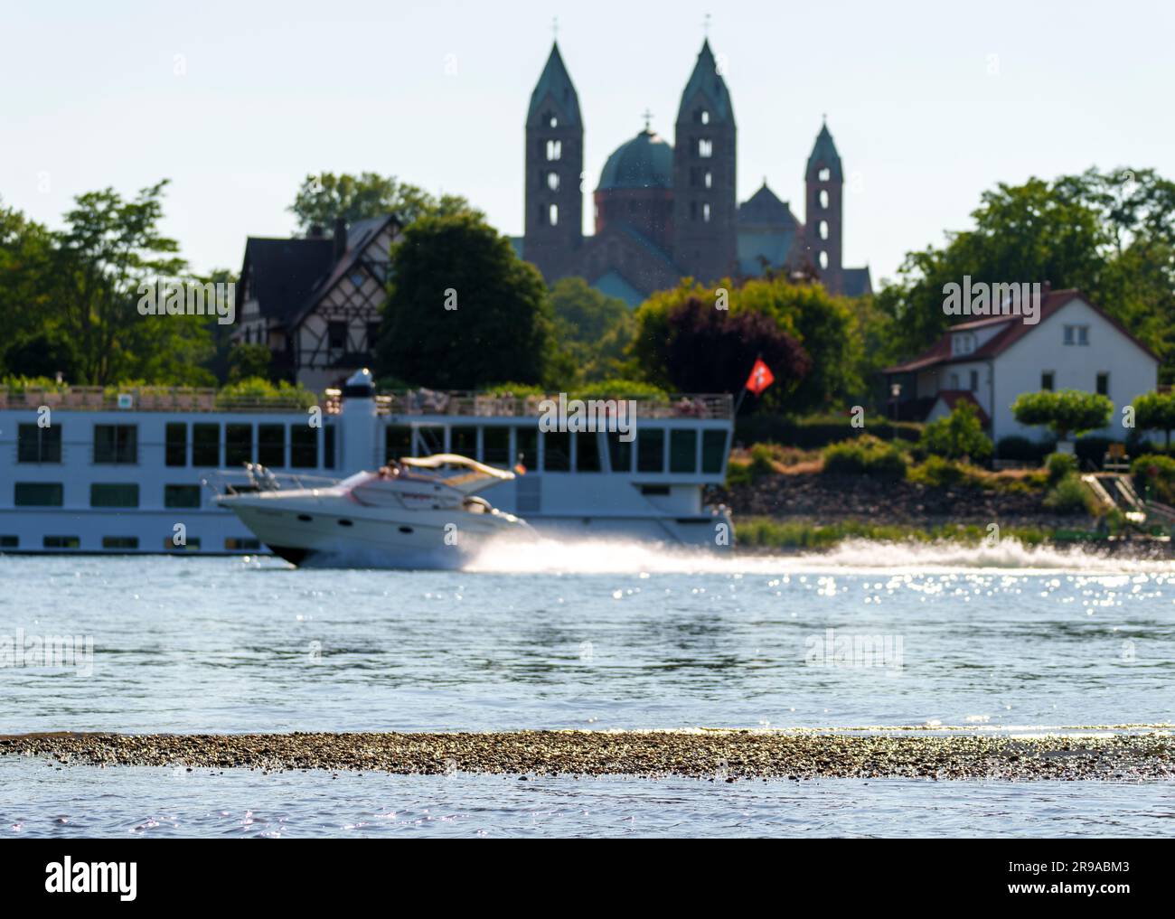 Speyer, Germany. 25th June, 2023. A motor yacht passes the silhouette ...