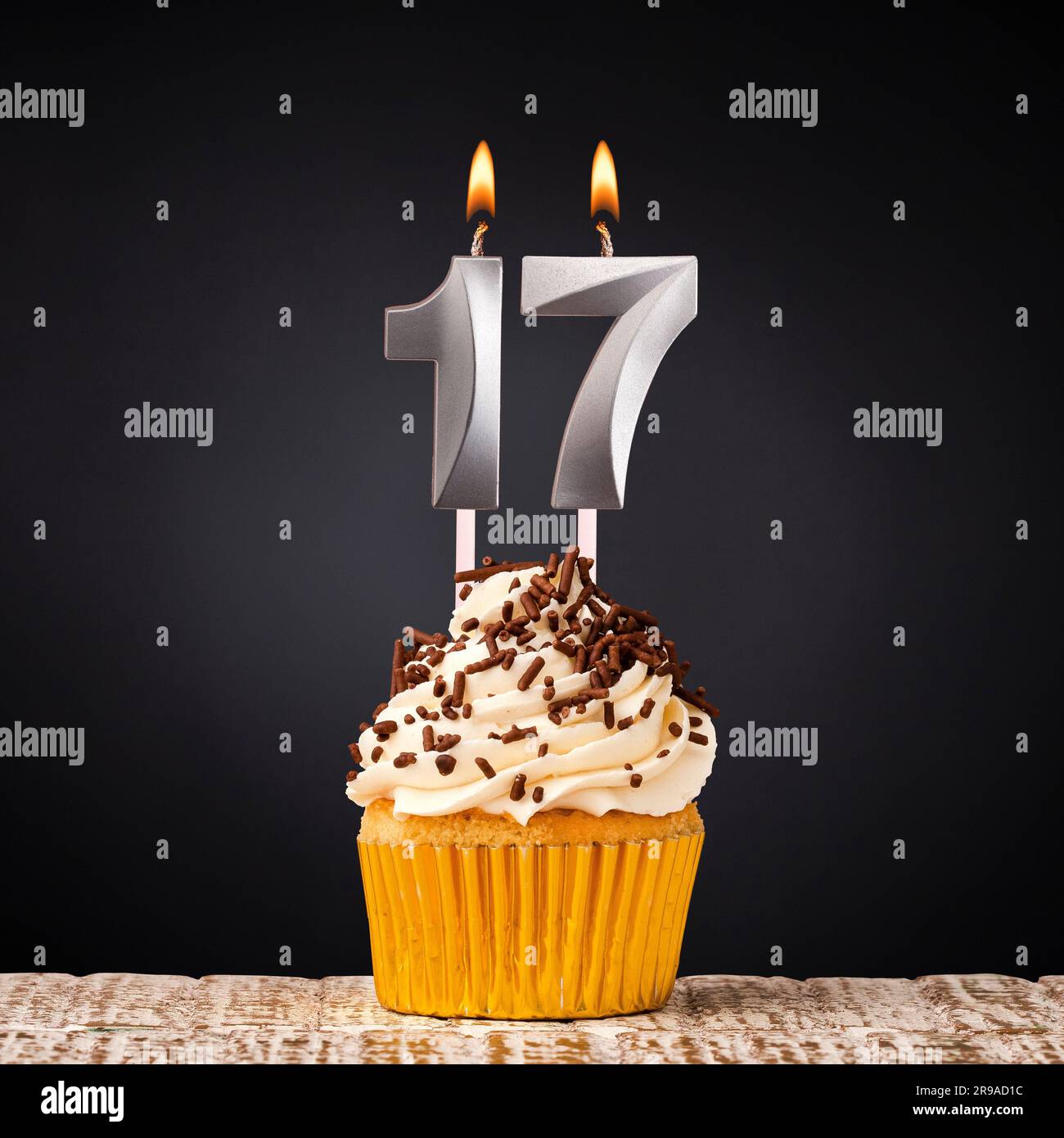 Birthday candle number 17 - Anniversary cupcake on black background ...
