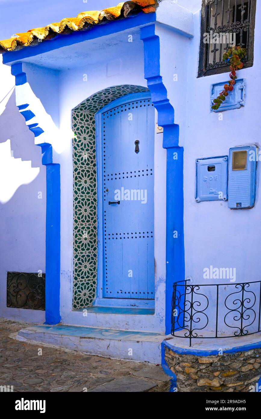 A front door entrance in a variety of blue paint and tiles for a ...
