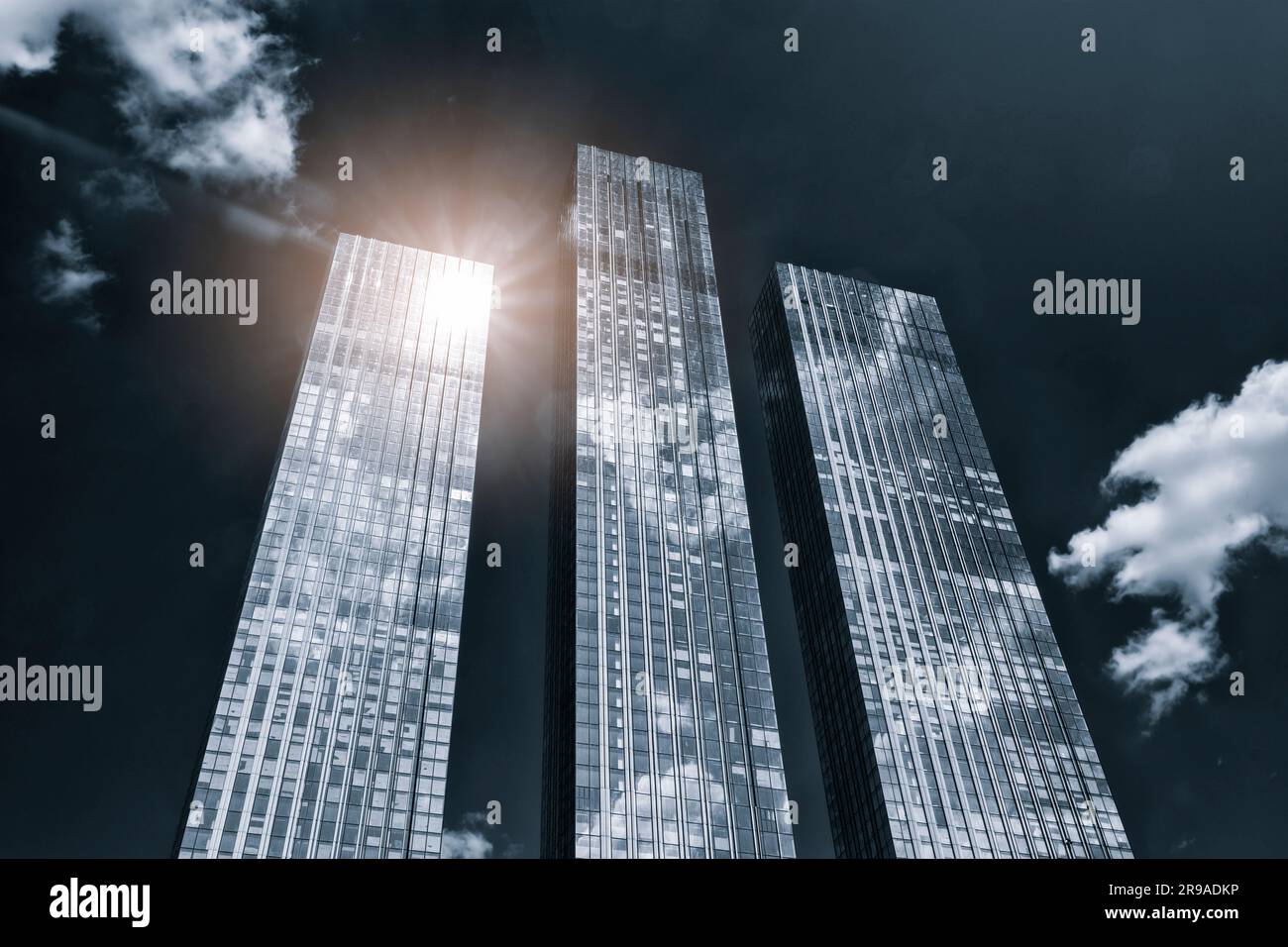 Tops of modern corporate buildings against the gloomy red sunset sky ...