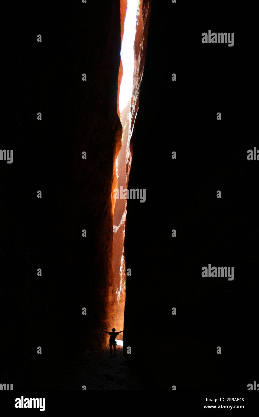 Person standing in a sunbeam shining into the narrow cleft between the ...