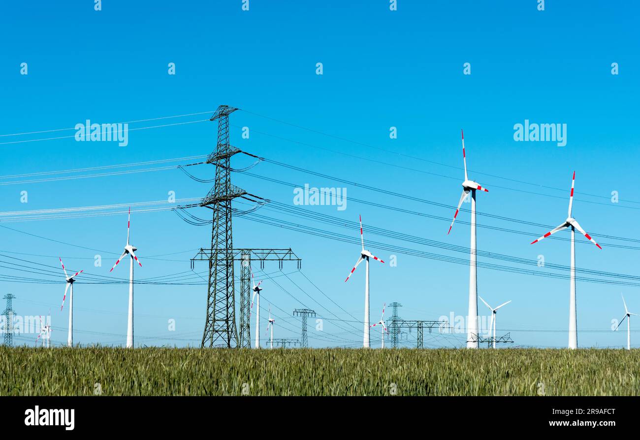 Wind turbines and power lines with masts in Germany Stock Photo - Alamy