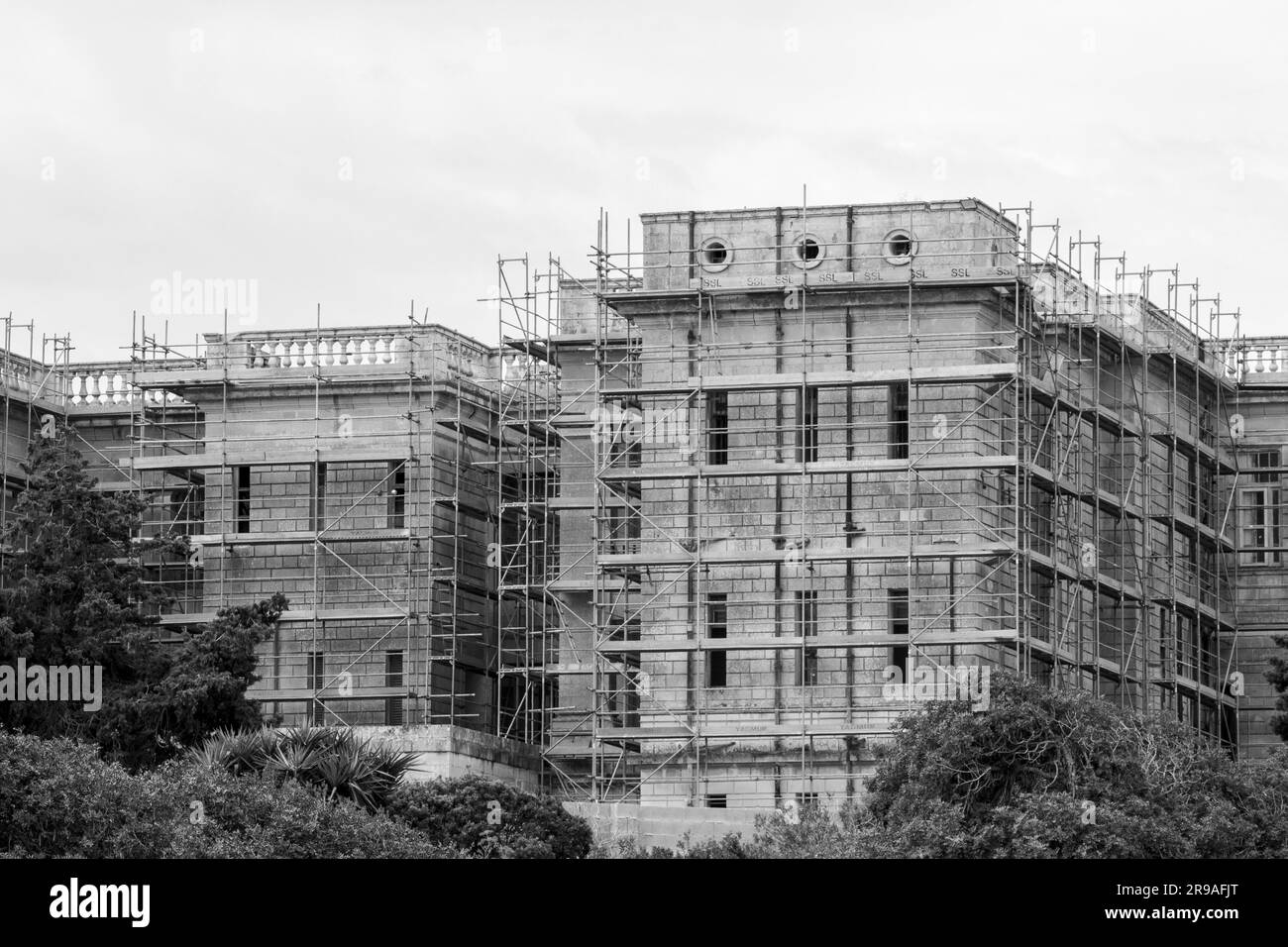 A grayscale shot of buildings under construction in the daylight Stock ...