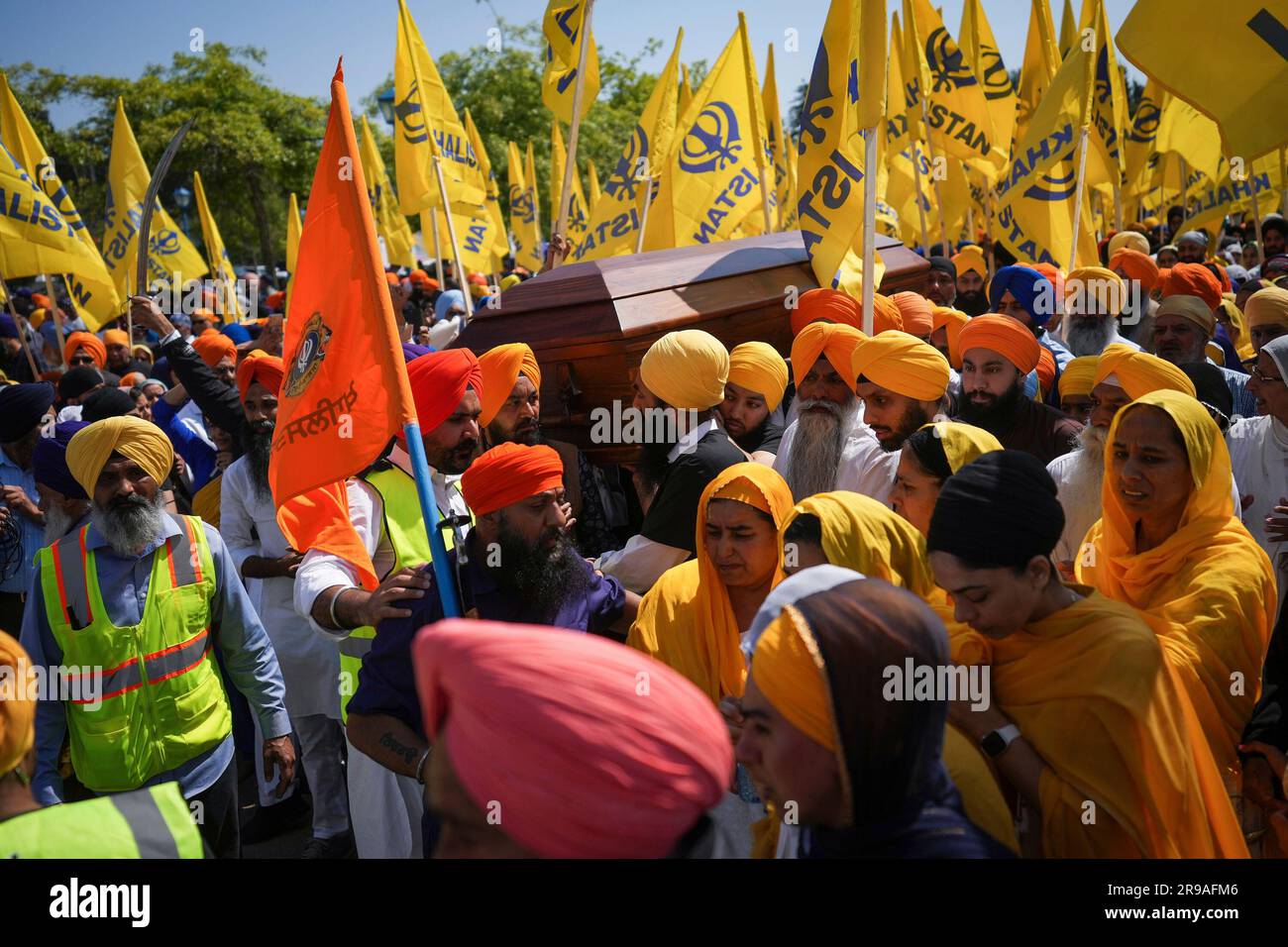 Mourners carry the casket of Sikh community leader and temple president Hardeep Singh Nijjar ...
