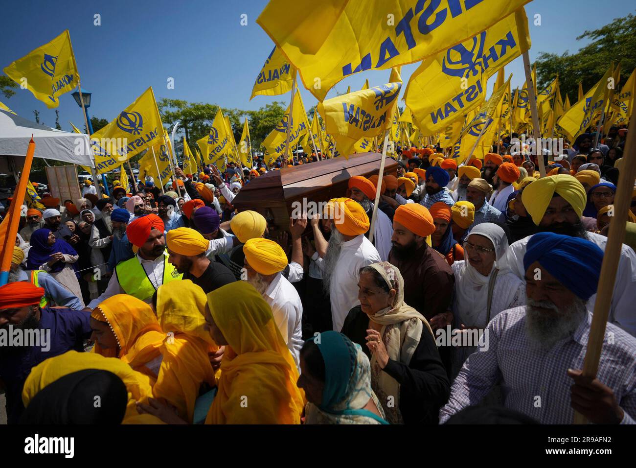 Mourners carry the casket of Sikh community leader and temple president Hardeep Singh Nijjar ...