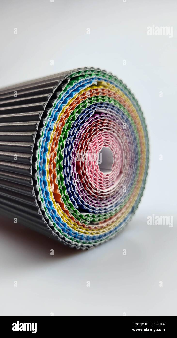 A roll of colored corrugated paper on a white background Stock Photo ...