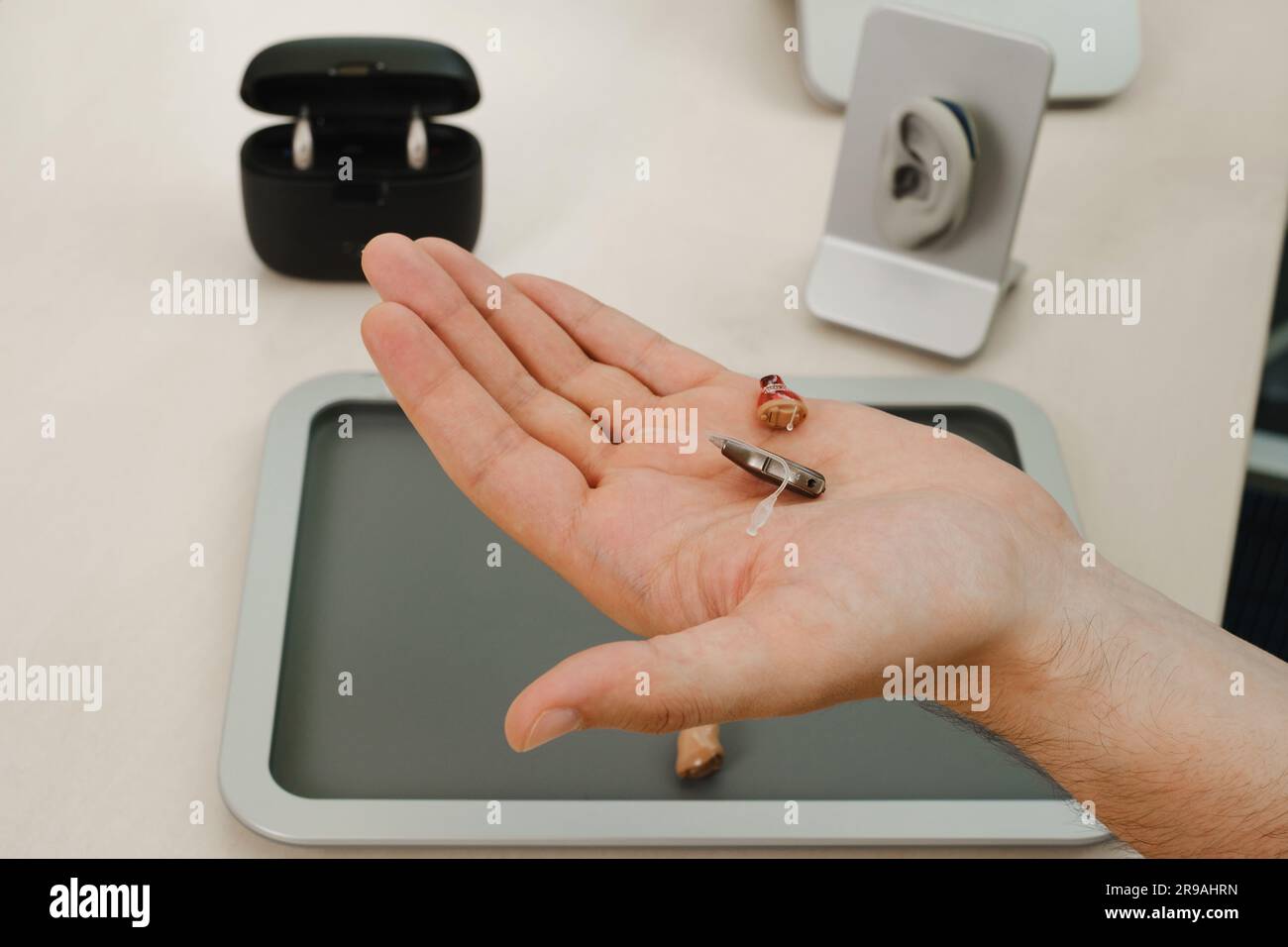 Modern miniature hearing aids. Small and discreet invisible hearing ...