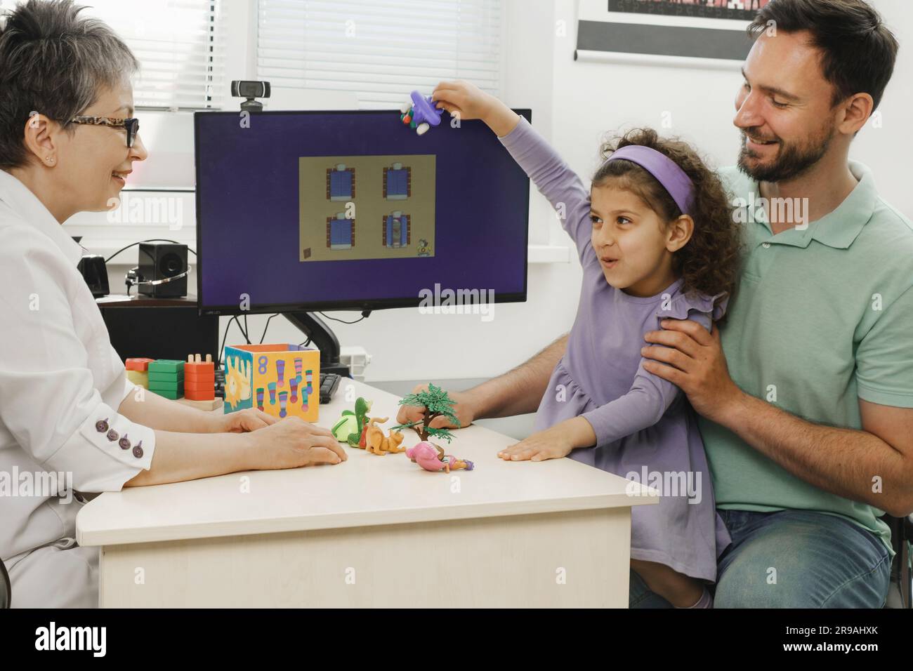 speech therapist working with child who has hearing problems ...