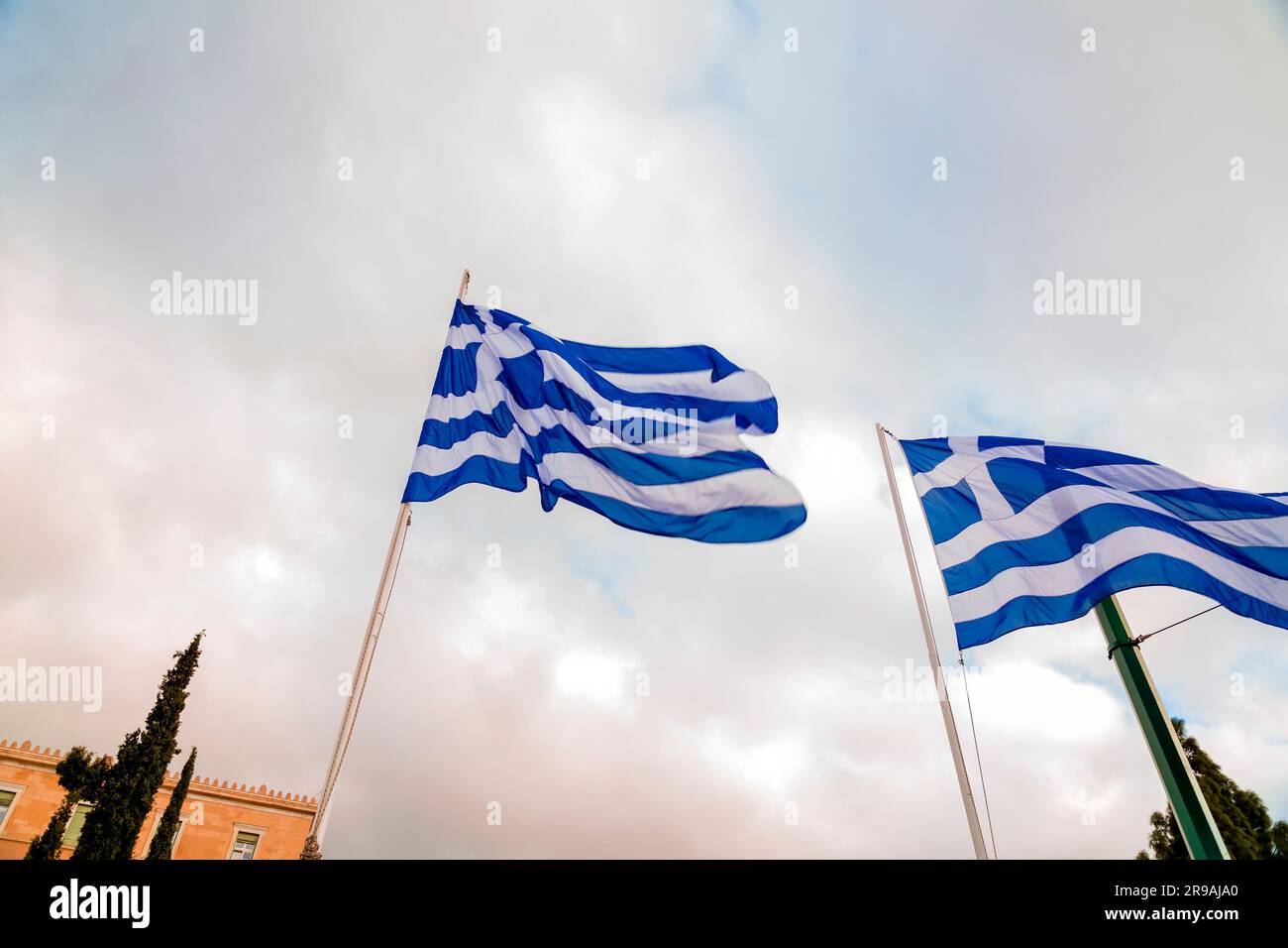 Fabric Greek flag waving on a flag pole against the sky Stock Photo - Alamy