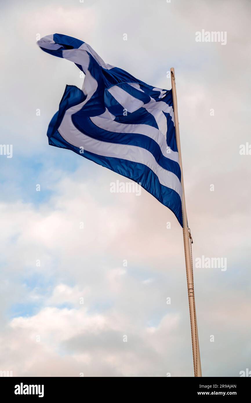 Fabric Greek flag waving on a flag pole against the sky Stock Photo - Alamy