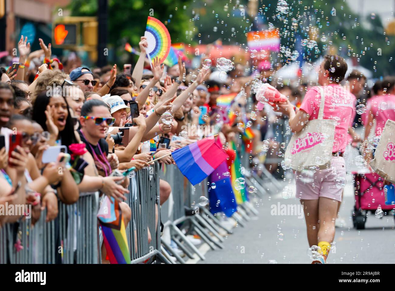 New York, United States. 25th June, 2023. A parade participant releases ...