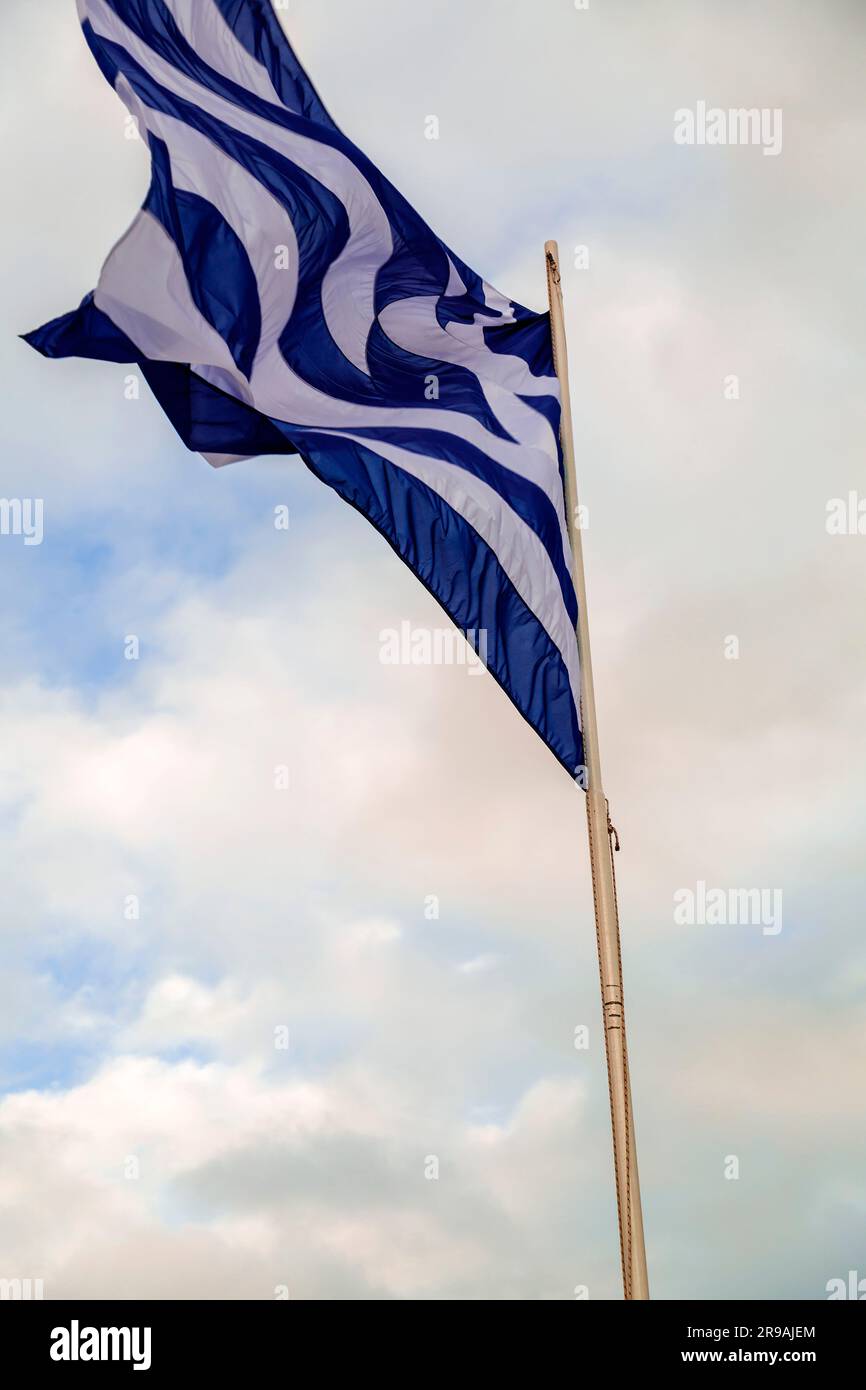Fabric Greek flag waving on a flag pole against the sky Stock Photo - Alamy