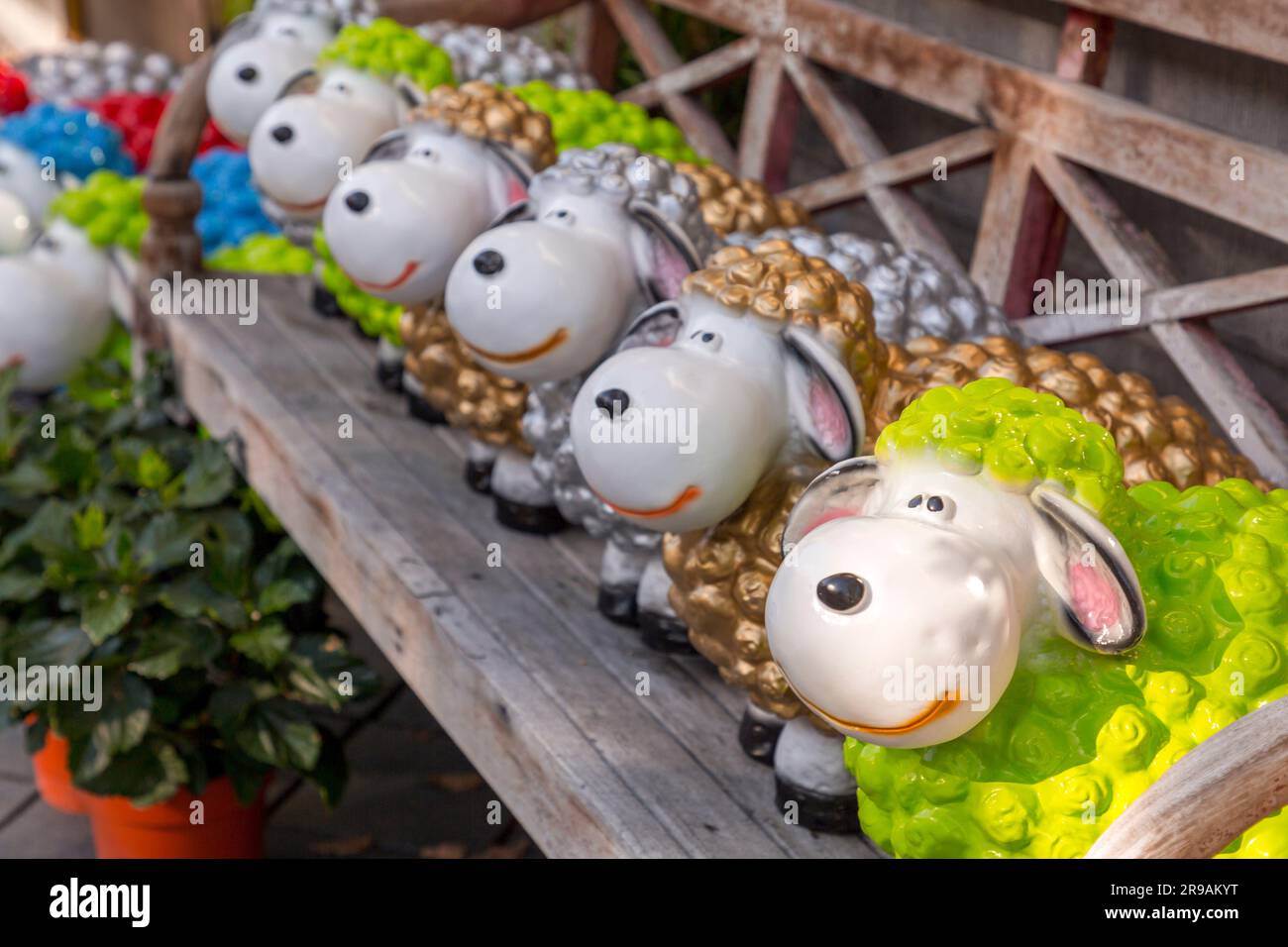 Row of ceramic sheep figurines, colorful garden decorations Stock Photo ...