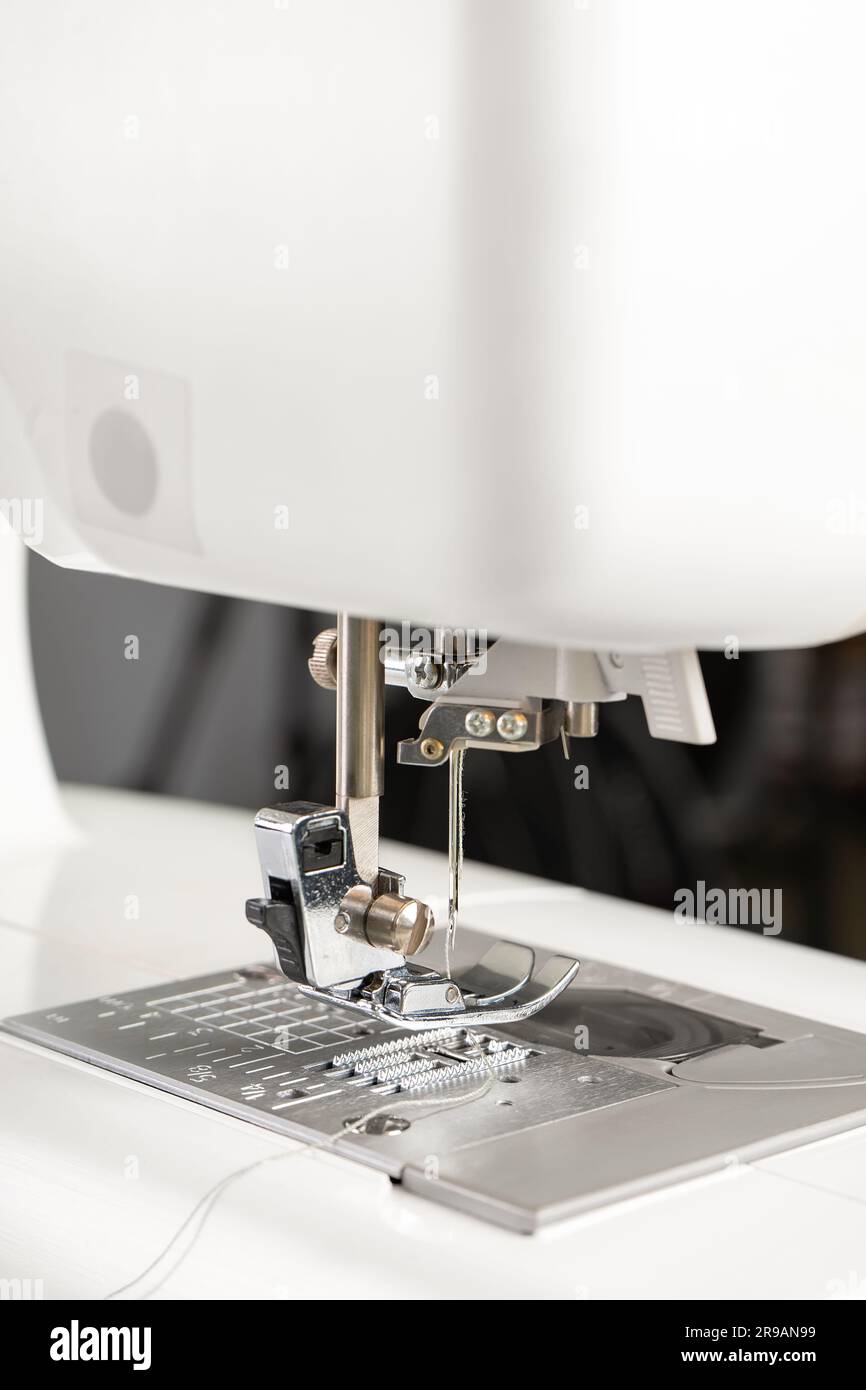 Modern white sewing machine presser foot closeup, macro. Sewing ...