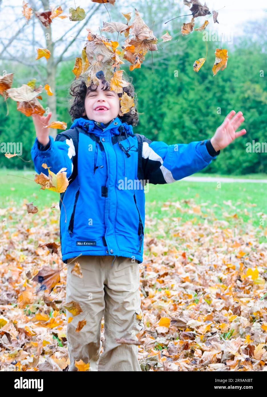 Hispanic child boy playing park during Autumn season, Toronto, Canada ...