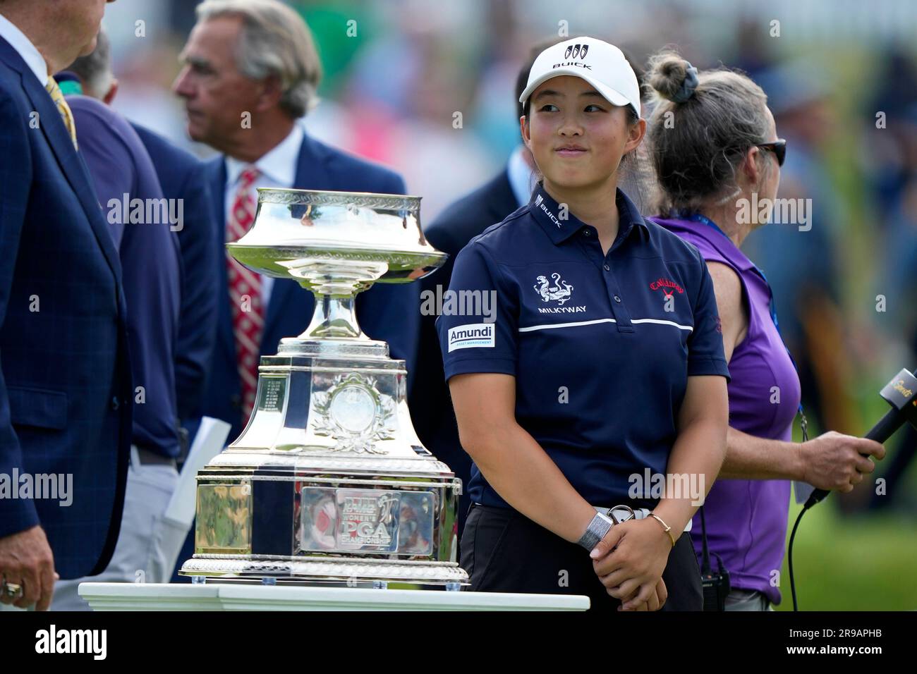 Ruoning Yin, of China, stands next to the trophy after winning the ...