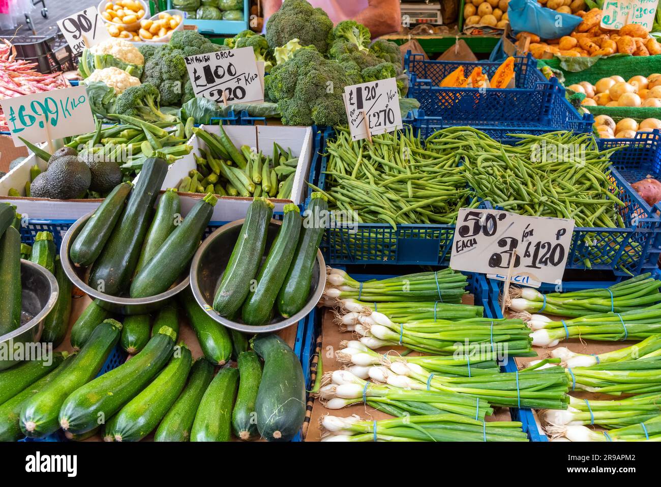 Courgettes, spring onions and other vegetables at a market in London ...