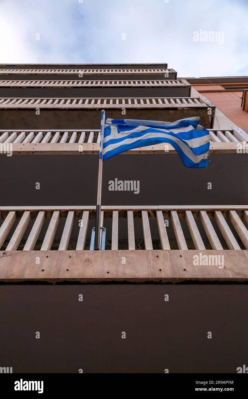 Fabric Greek flag waving on a flag pole on a balcony in Athens, Greece ...