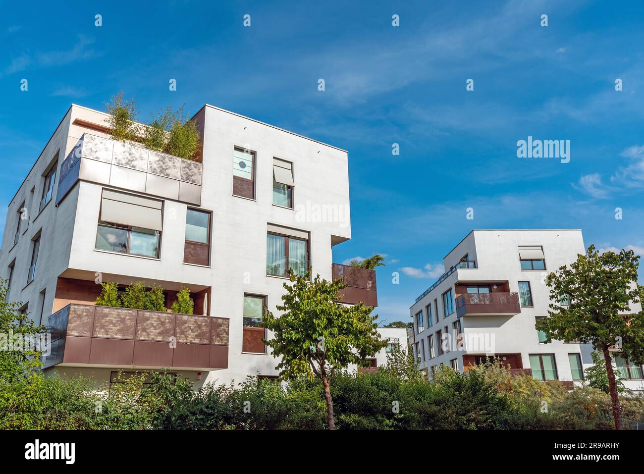 Modern white apartment buildings under blue skies seen in Berlin ...