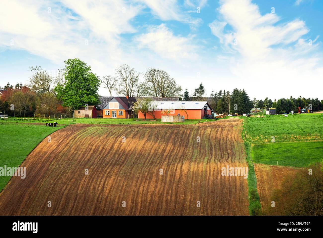 Farm on the top of a hill with cultivated fields under a blue sky Stock ...