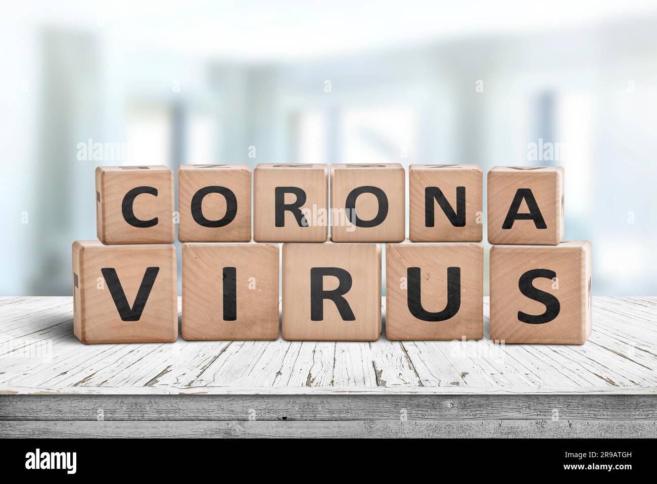 Corona virus alert message on a worn wooden desk i a bright environment ...