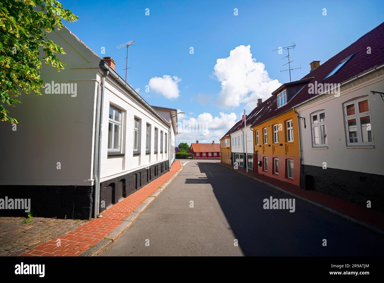 Empty street in a small danish village with colorful buildings in the ...
