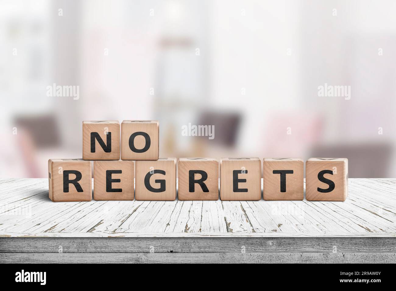 No regrets sign made with wooden blocks on a table in a bright room ...