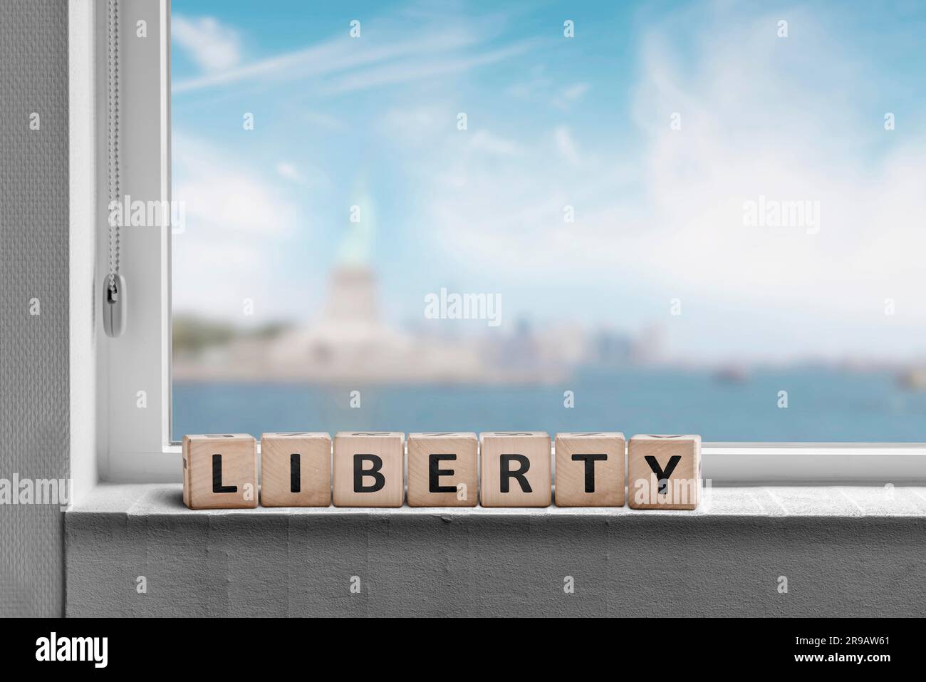 Liberty sign in a window sill with a view to the statue of liberty ...
