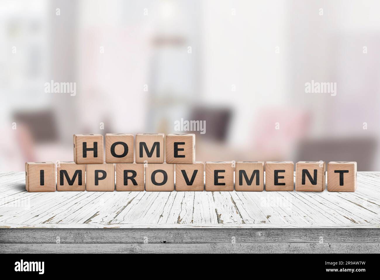 Home improvement sign in a bright room on a wooden desk in white paint ...