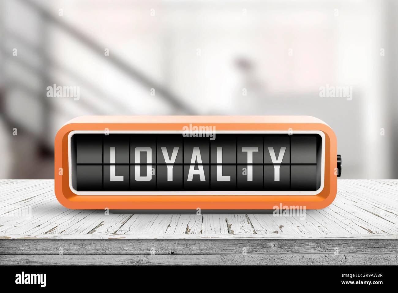 Loyalty message on a retro alarm clock in orange color in a bright room ...