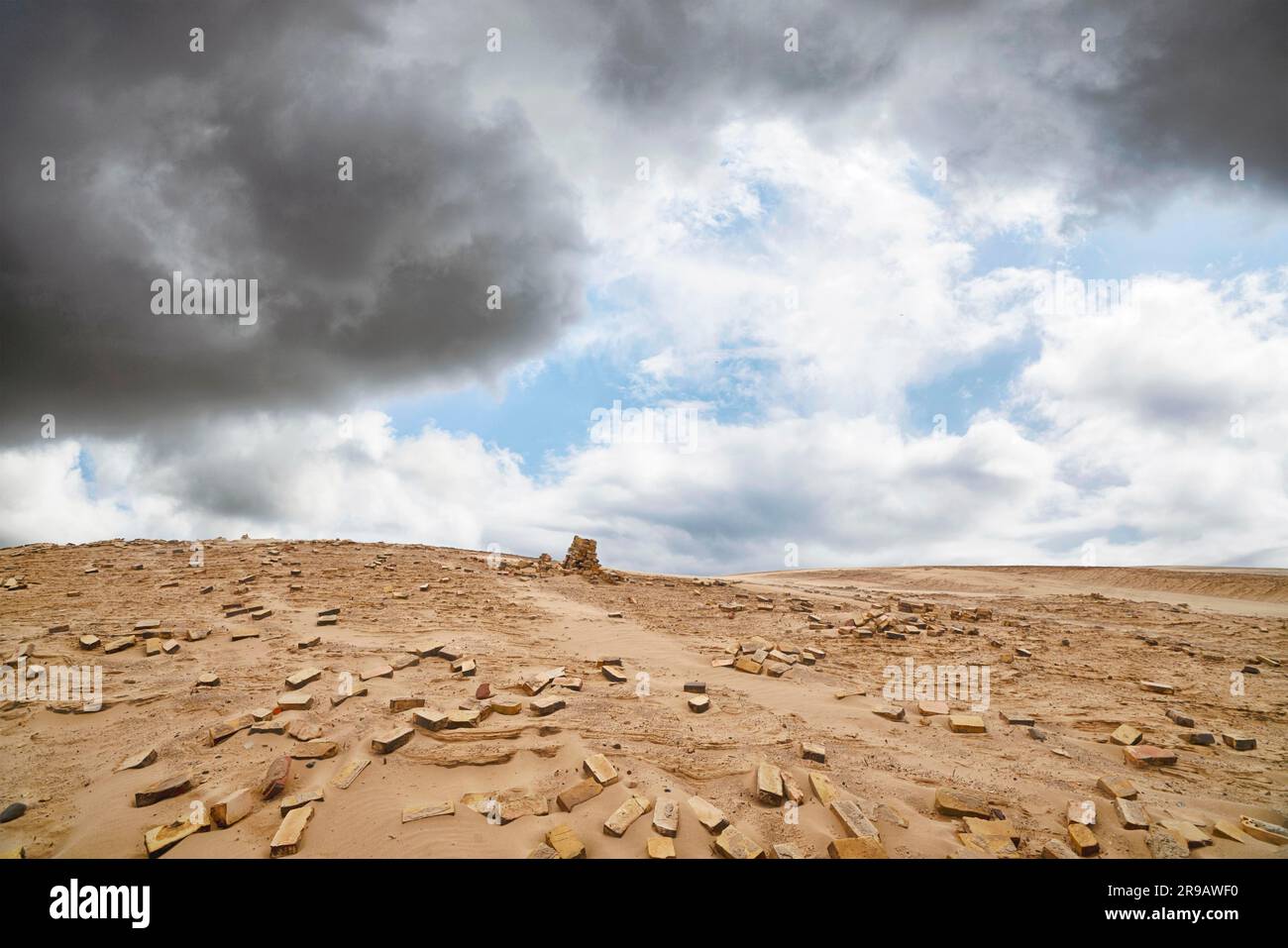 Bricks in a dry desert in cloudy weather with a stack of stones Stock ...