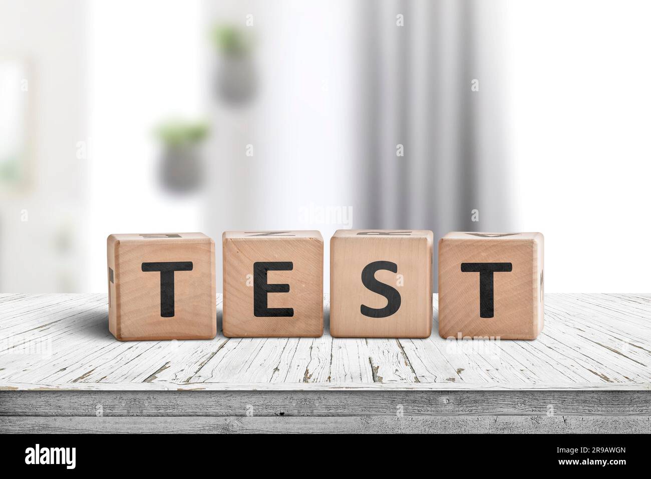 Test sign made of wood with text in a bright living room on a desk ...