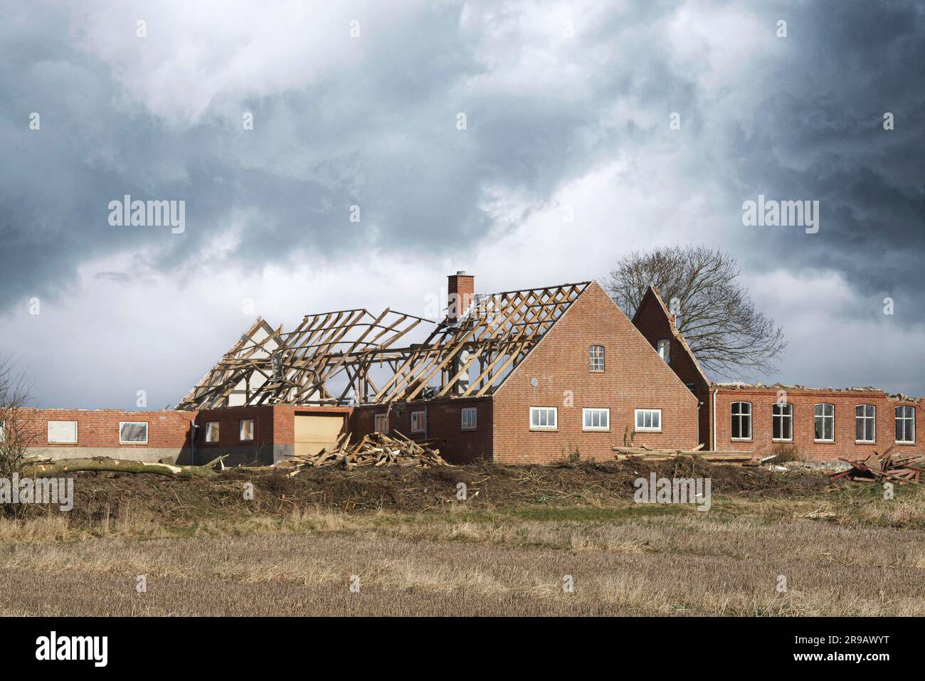 House damaged by a storm with roof destroyed under a cloudy sky Stock ...