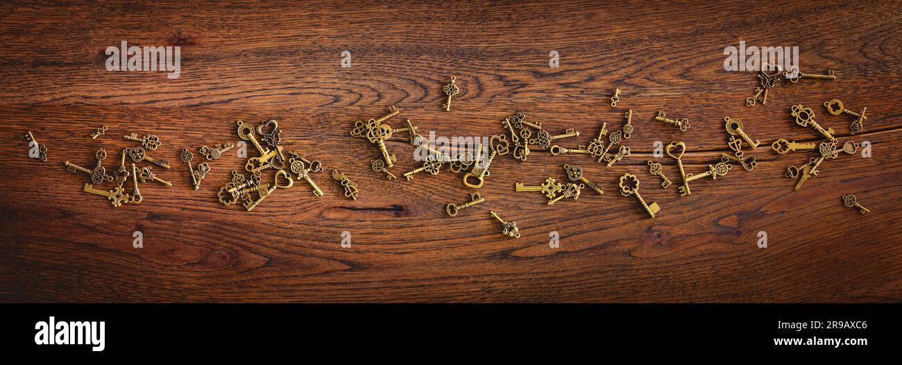 Magical bronze keys on a wooden oak surface in panorama format Stock ...