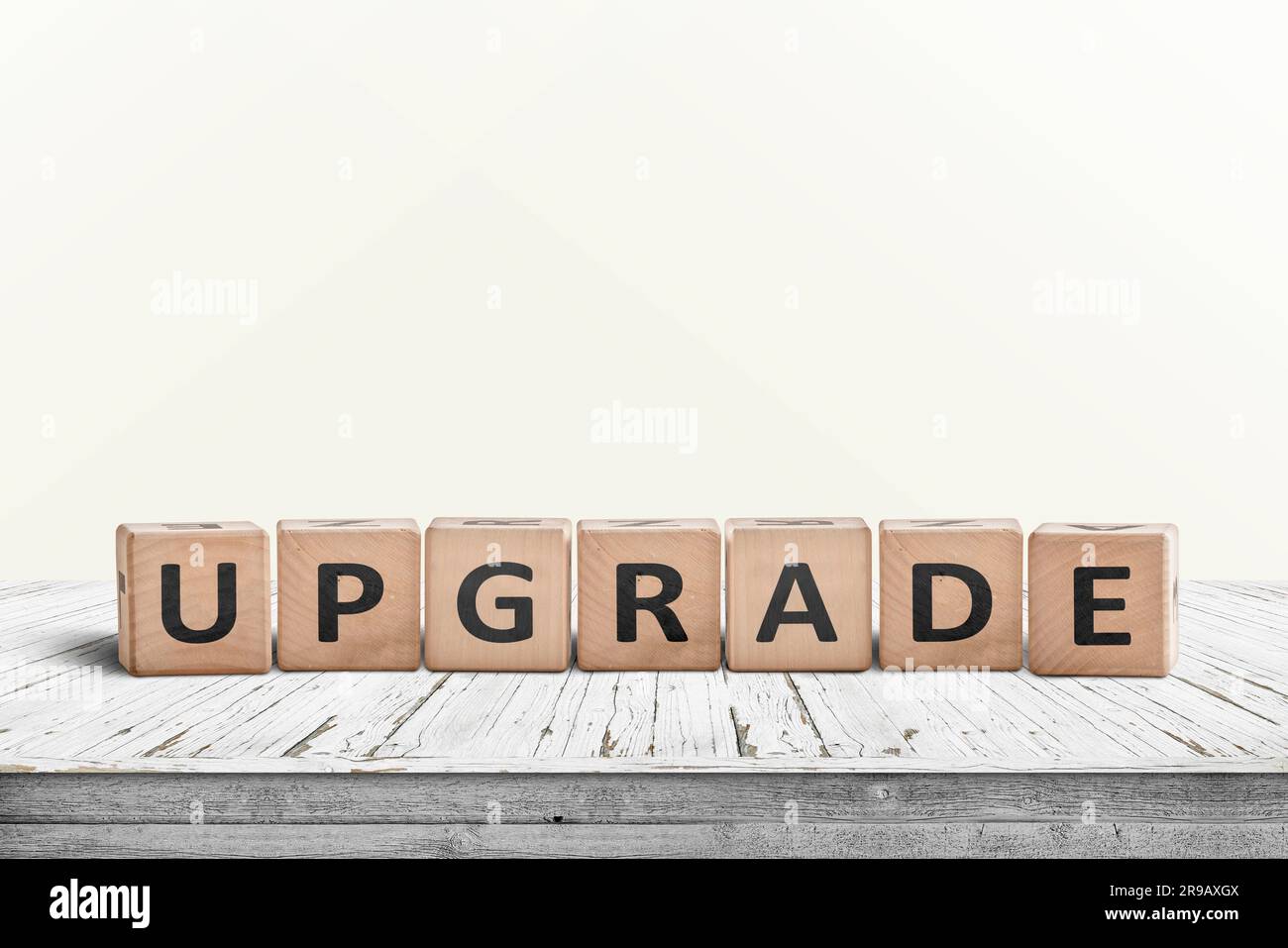 Upgrade sign made with wooden blocks on a worn table in a bright room ...